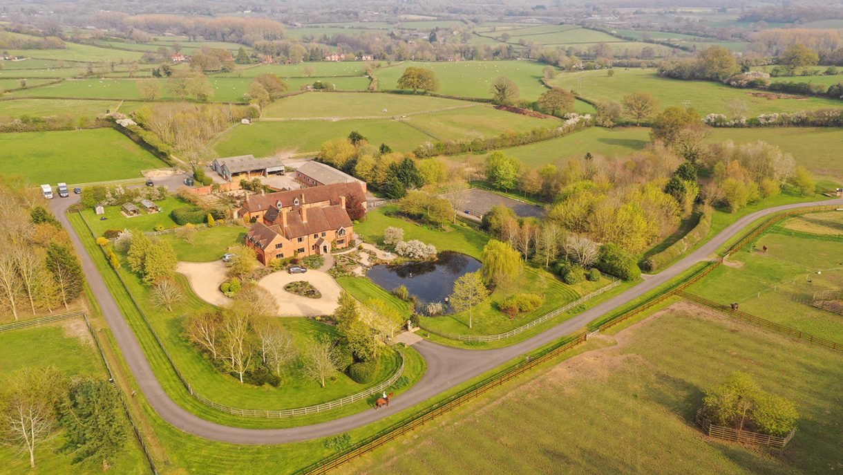 A sprawling countryside set-up, complete with 12 stables, outdoor arena ...