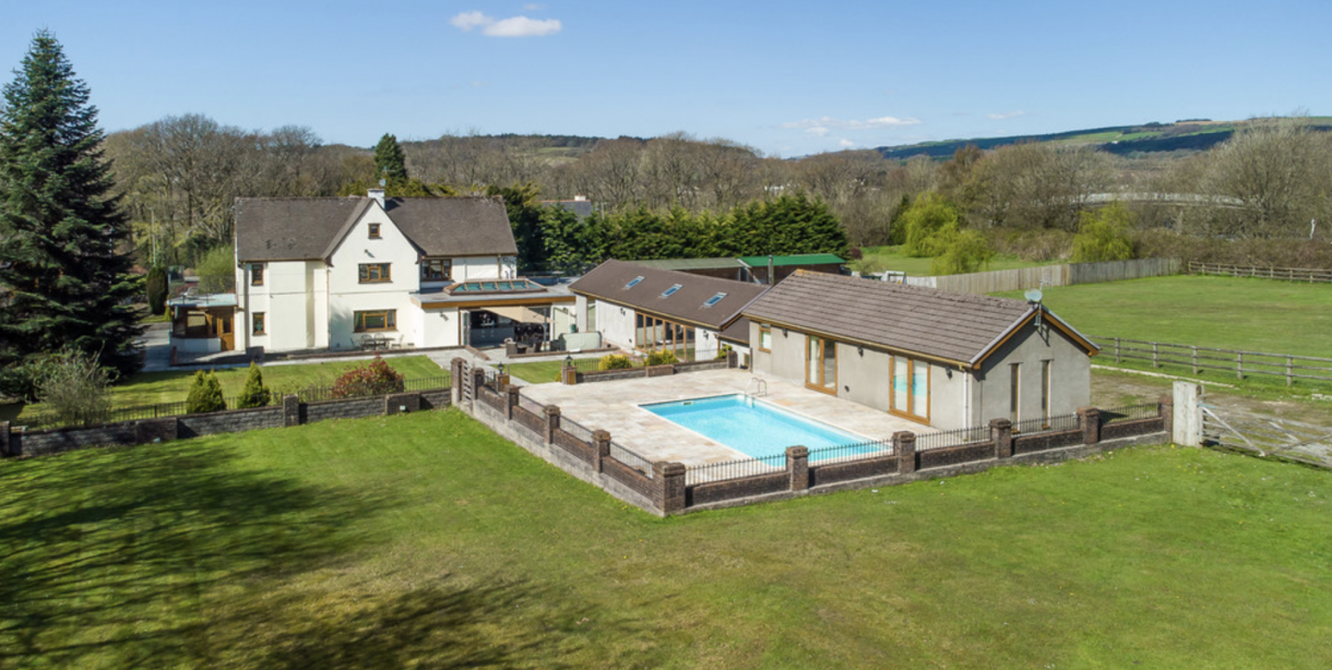 Move into this six-bedroom home, complete with stables, pool and gym ...