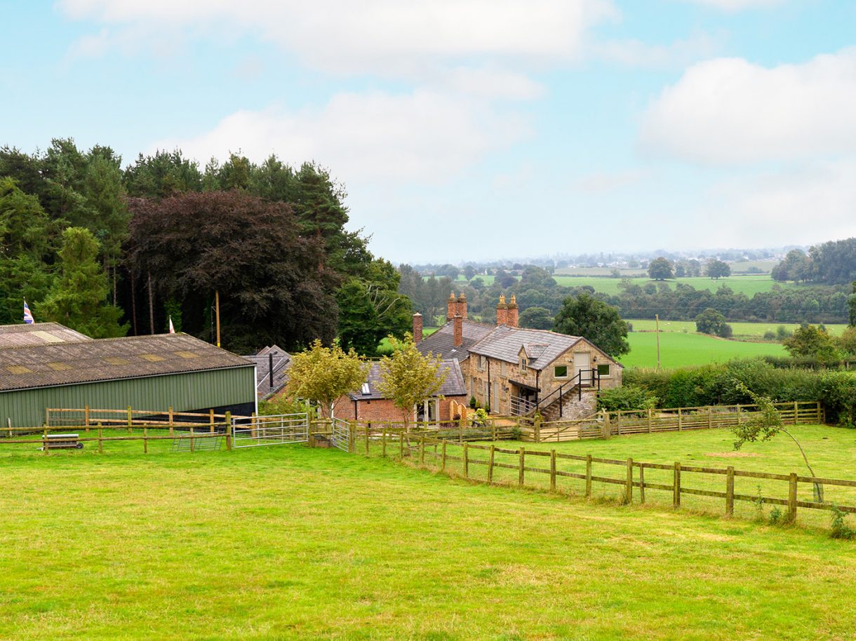 A historic property with a Grade II listed longhouse, indoor stables ...