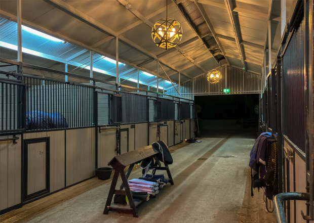 An equestrian centre with 26 stables, two all-weather arenas, high-tech ...
