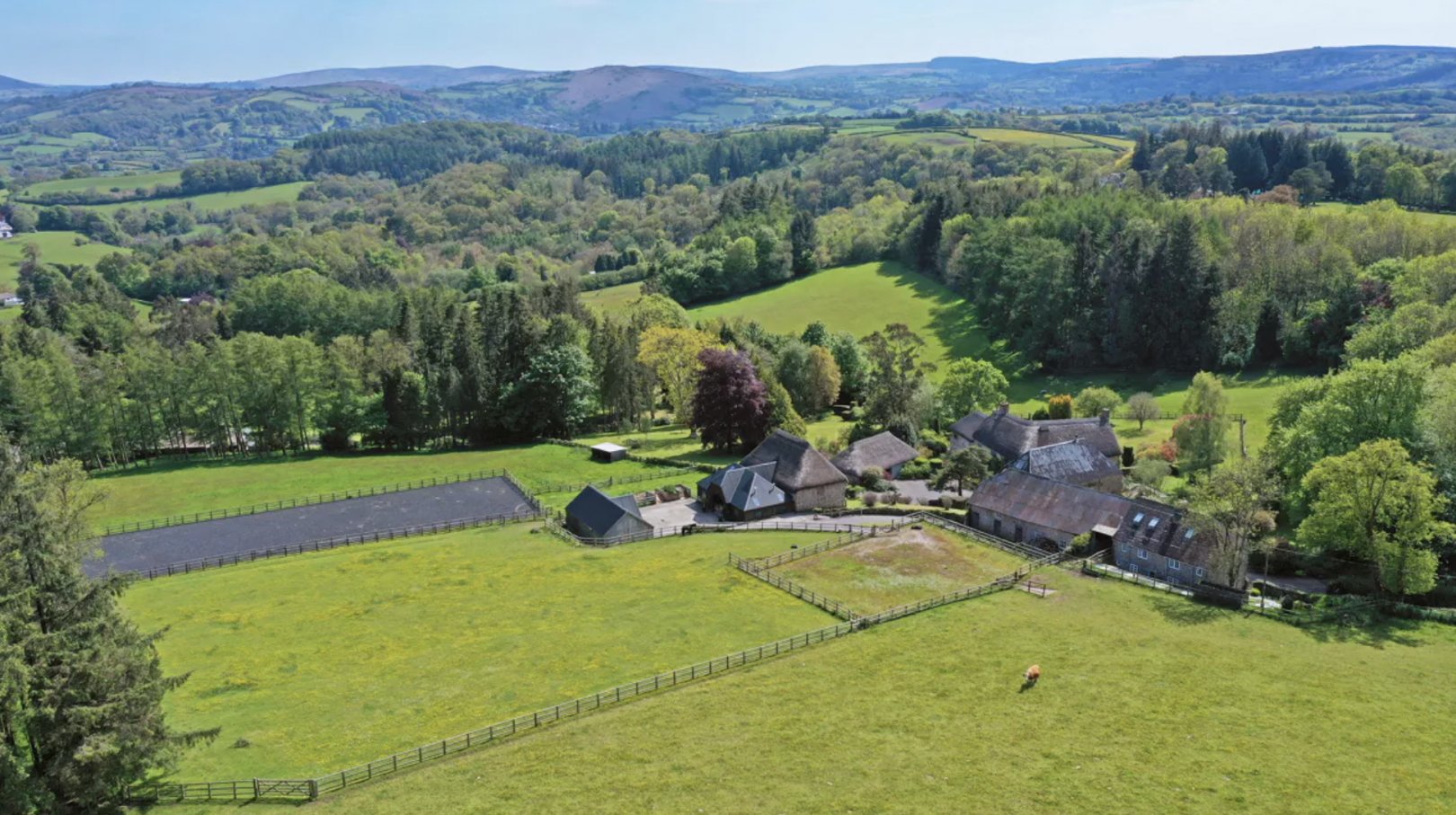 A 30-acre estate with Victorian-style stables, two arenas, guest ...