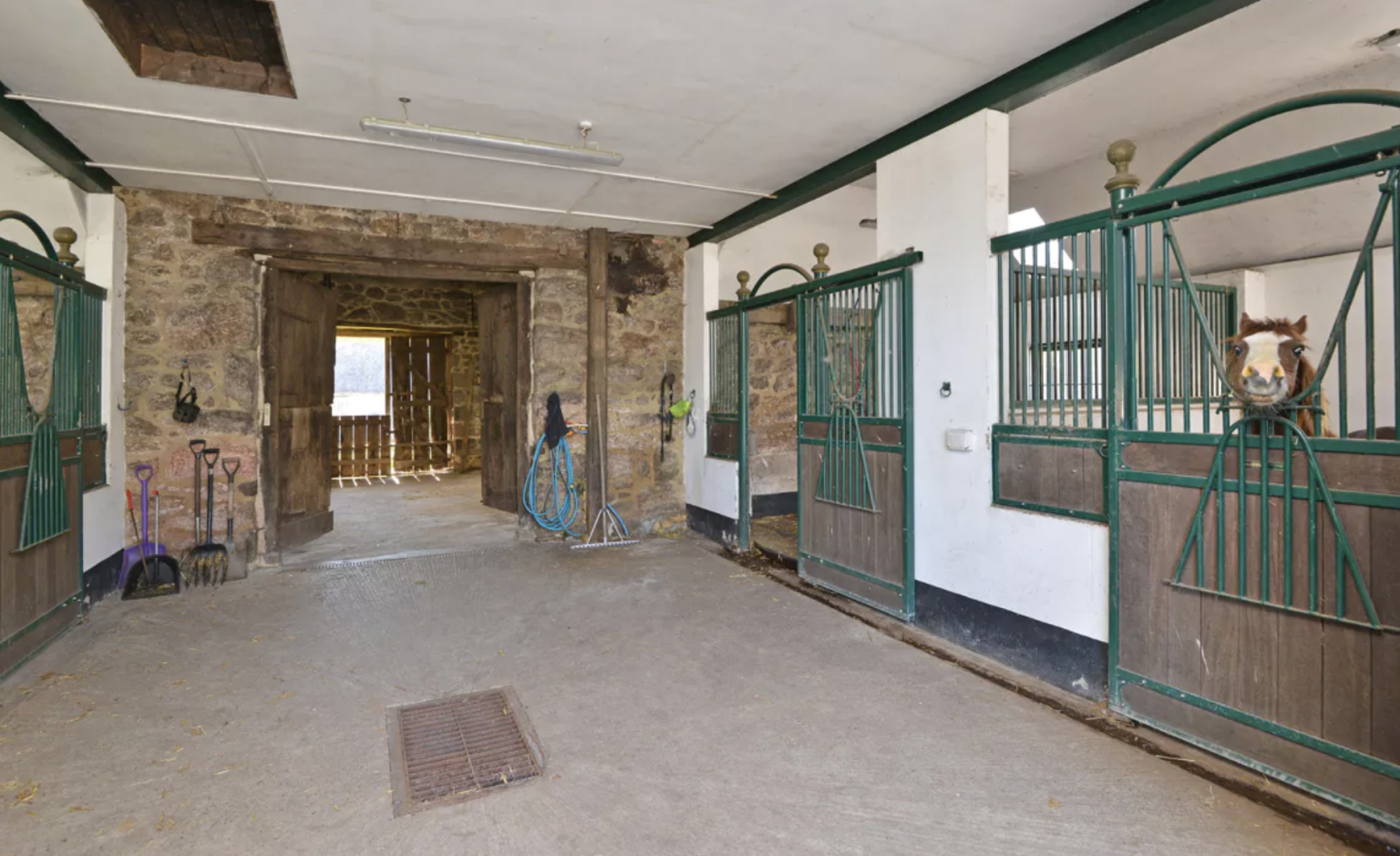 A 30-acre estate with Victorian-style stables, two arenas, guest ...