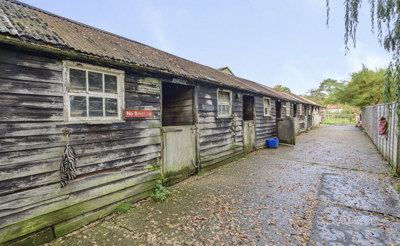Fancy a project? Check out this house with 16 stables, an indoor arena ...