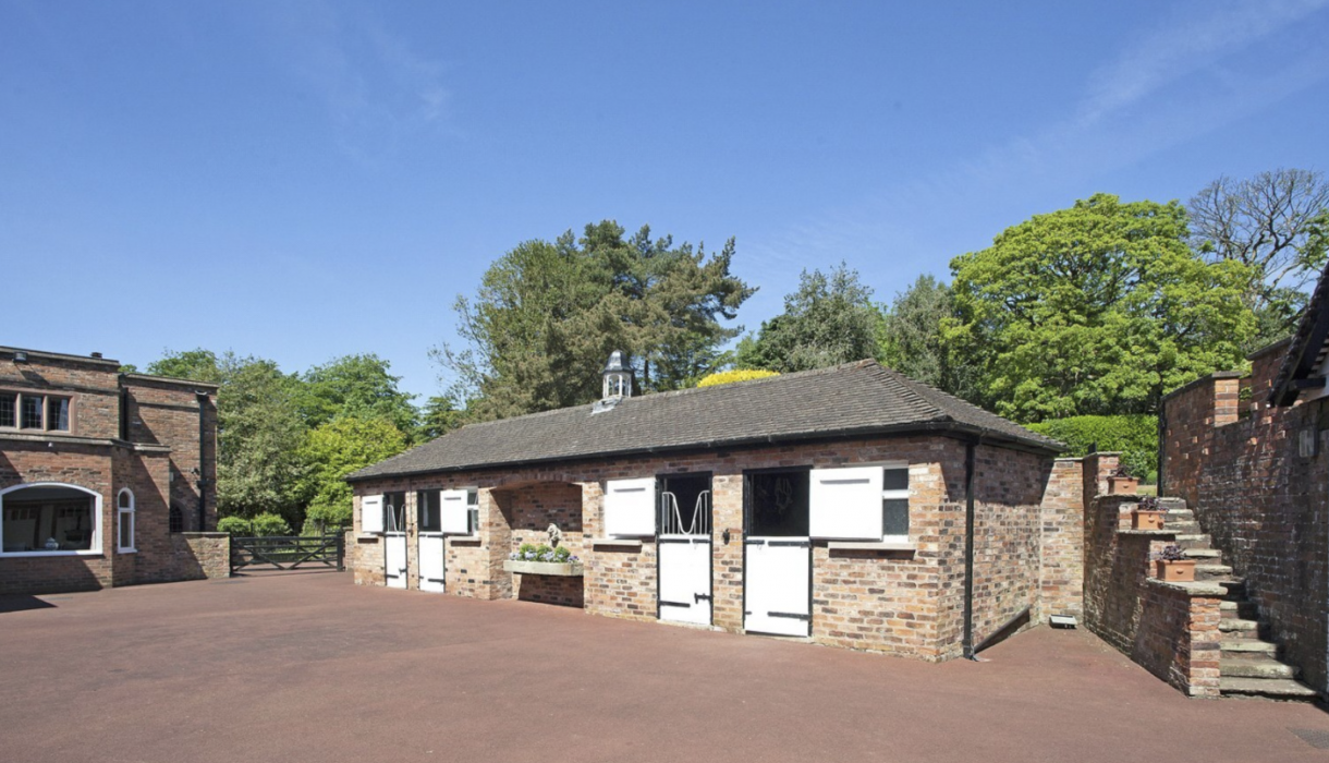 A sprawling equestrian property with plenty of stables, grazing, a pool ...