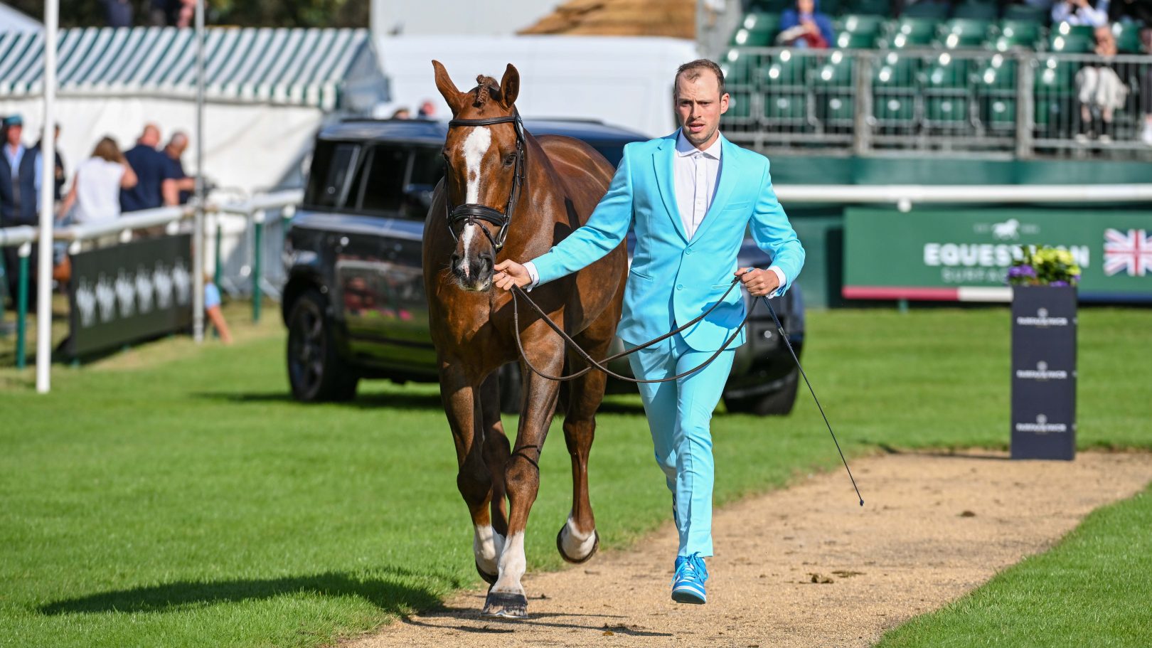 Burghley Horse Trials trot-up photos: a turquoise suit and orange shorts