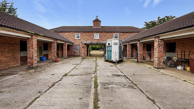 Settle at this four-bed home with 14 stables, two annexes, kennelling ...