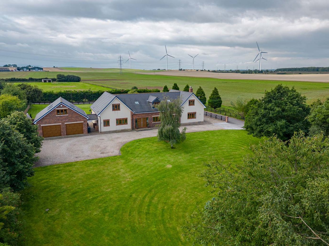 A six-bedroom country home with indoor stables, paddocks, a bar, and ...