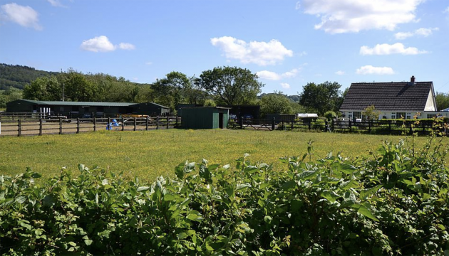 How about a cosy home with five stables, outdoor school and paddocks ...