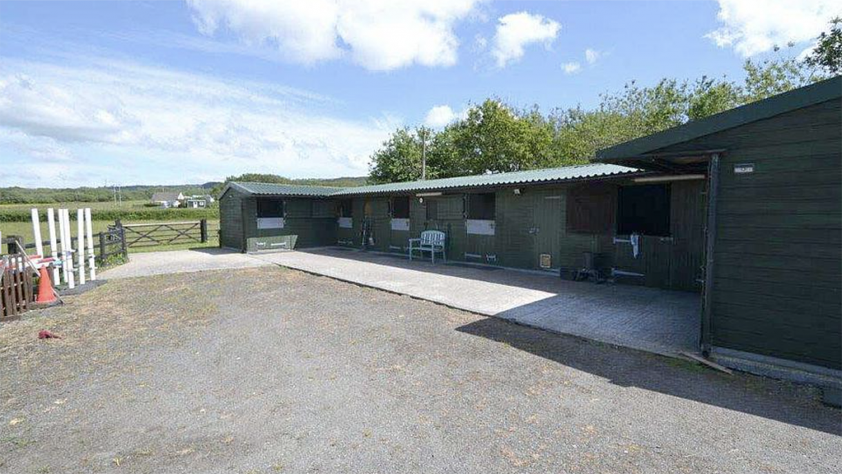 How about a cosy home with five stables, outdoor school and paddocks ...