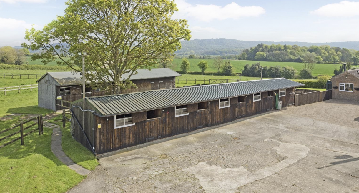 A home nestled in an idyllic spot, complete with stables, arena and ...