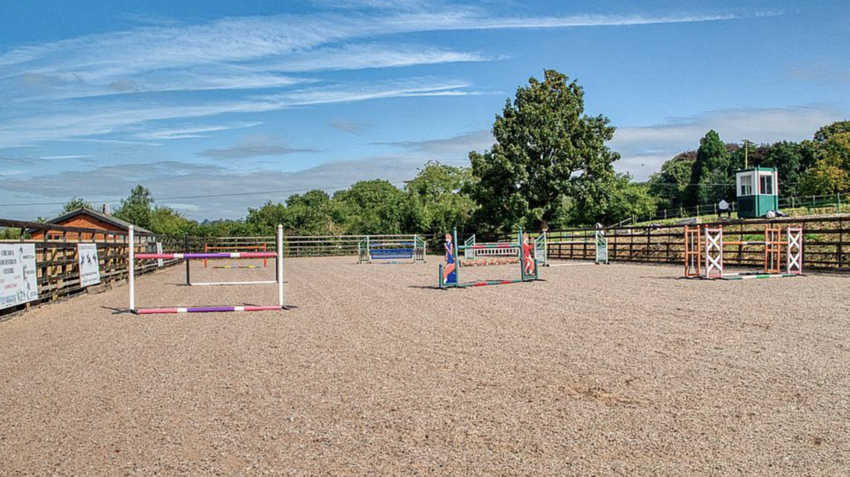 This equestrian set-up with stables, indoor and outdoor arenas, grazing ...