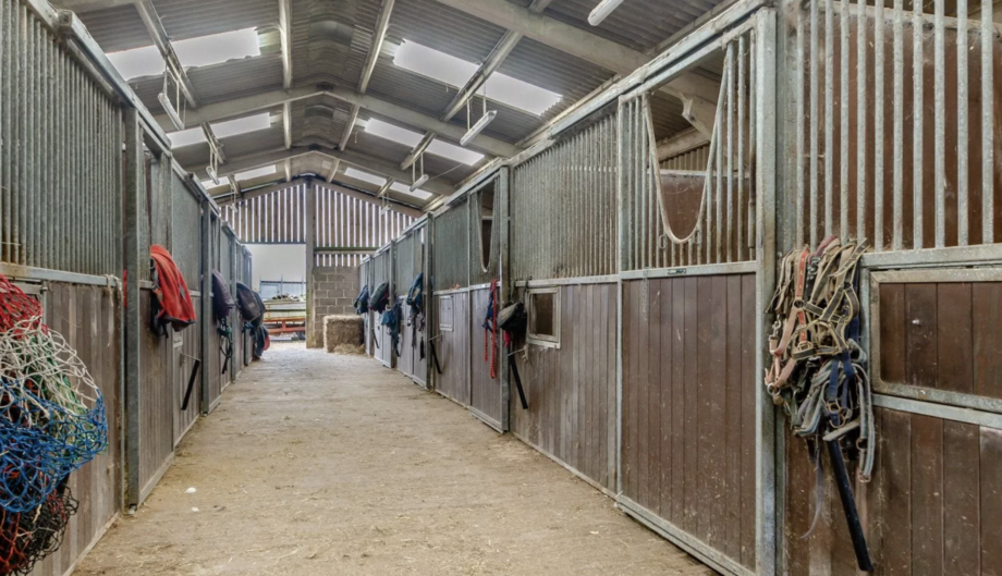 A beautifully renovated farmhouse complete with 10 stables, 33 acres ...