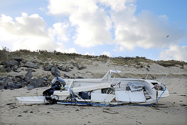 Small power boat wrecked on Guernsey beach - Practical Boat Owner